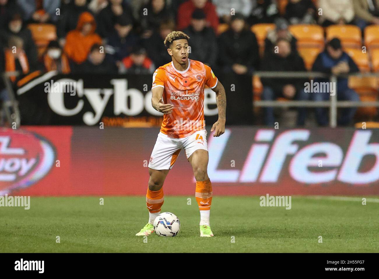 Jordan Gabriel #4 of Blackpool looks for assistance Stock Photo - Alamy