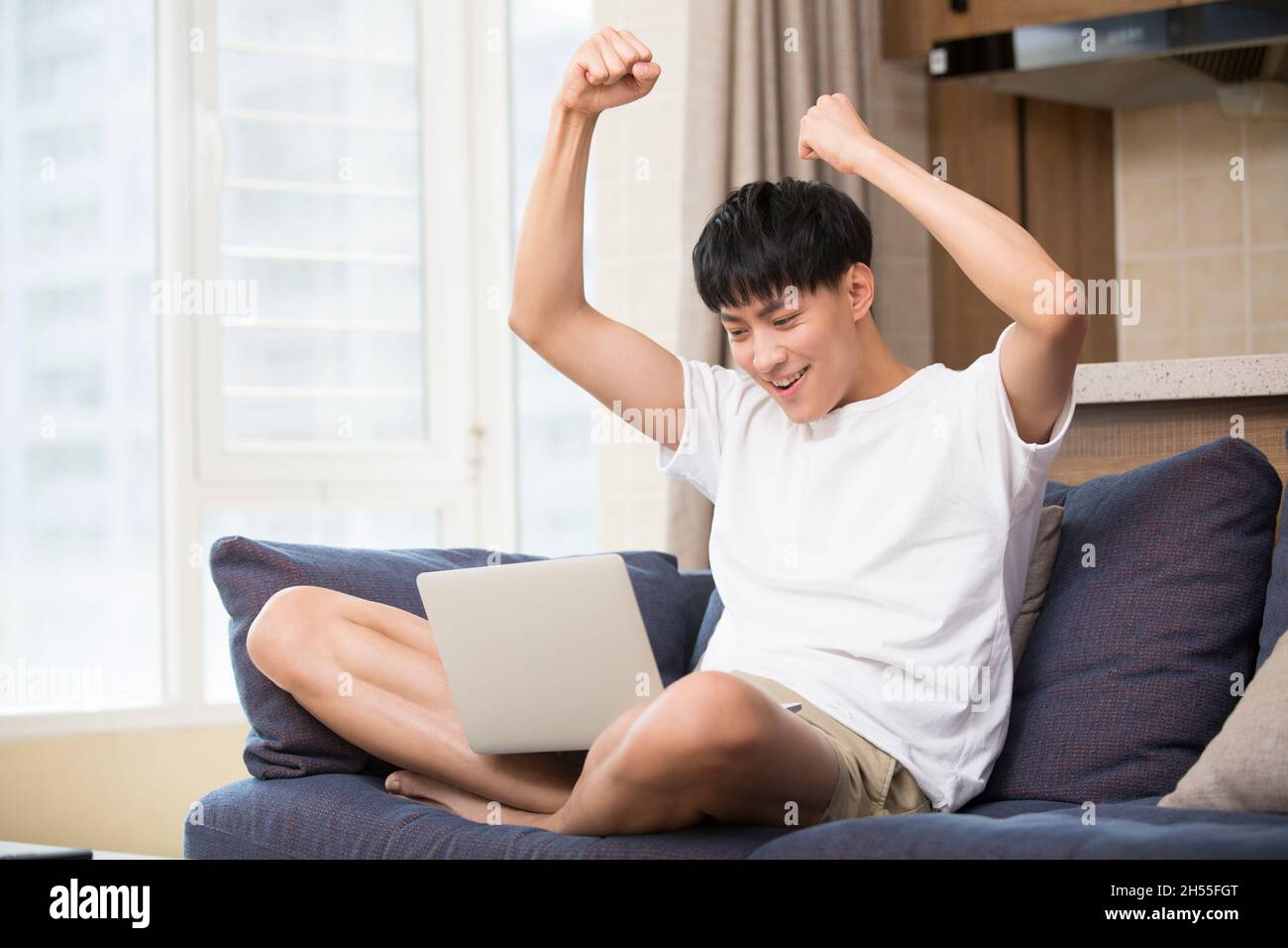 Young and handsome man cheering excitedly Stock Photo - Alamy