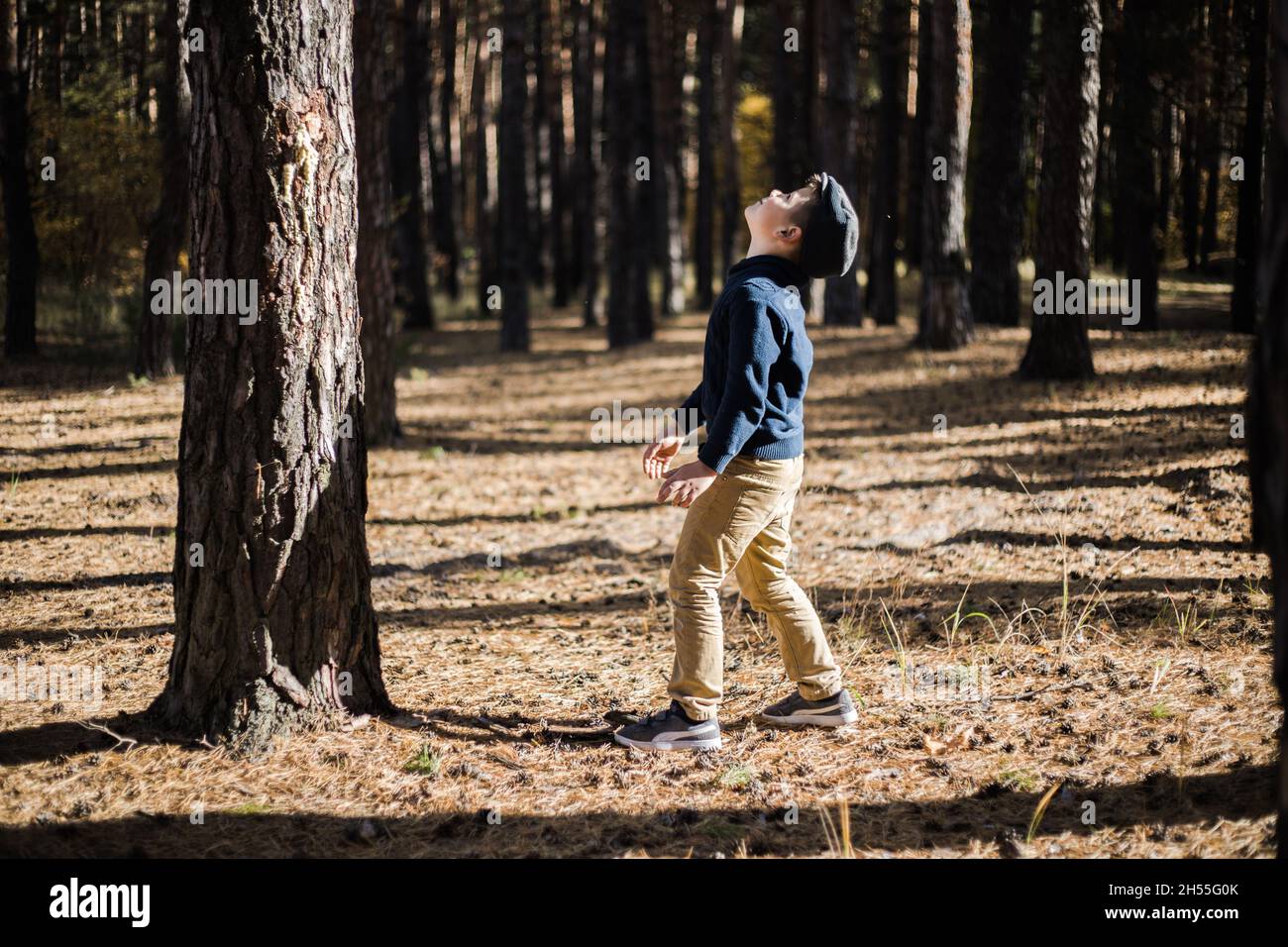 Portrait boy in hat. Happy Kid is playing in park outdoors Stock Photo ...