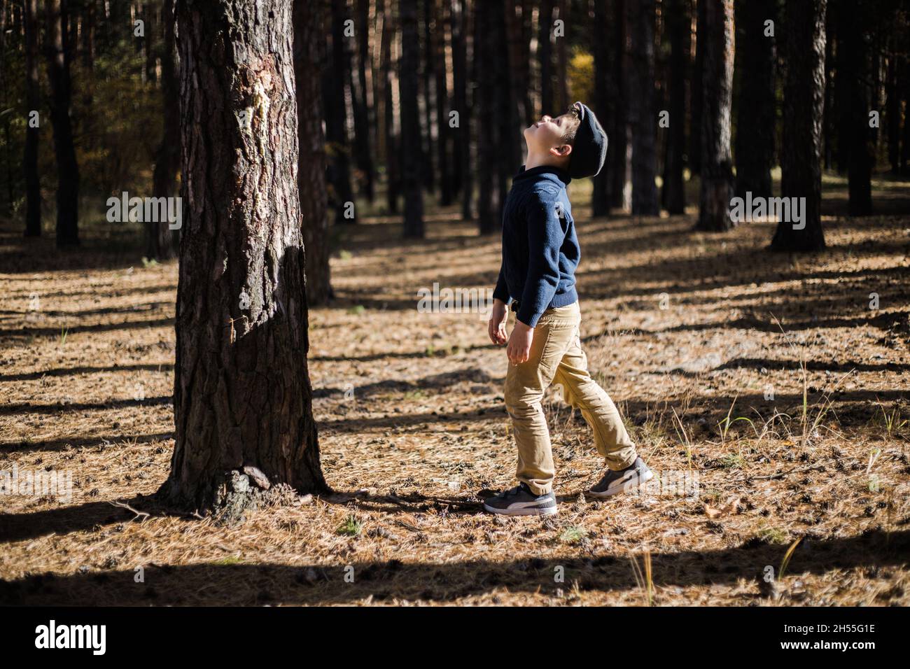 Portrait boy in hat. Happy Kid is playing in park outdoors Stock Photo ...