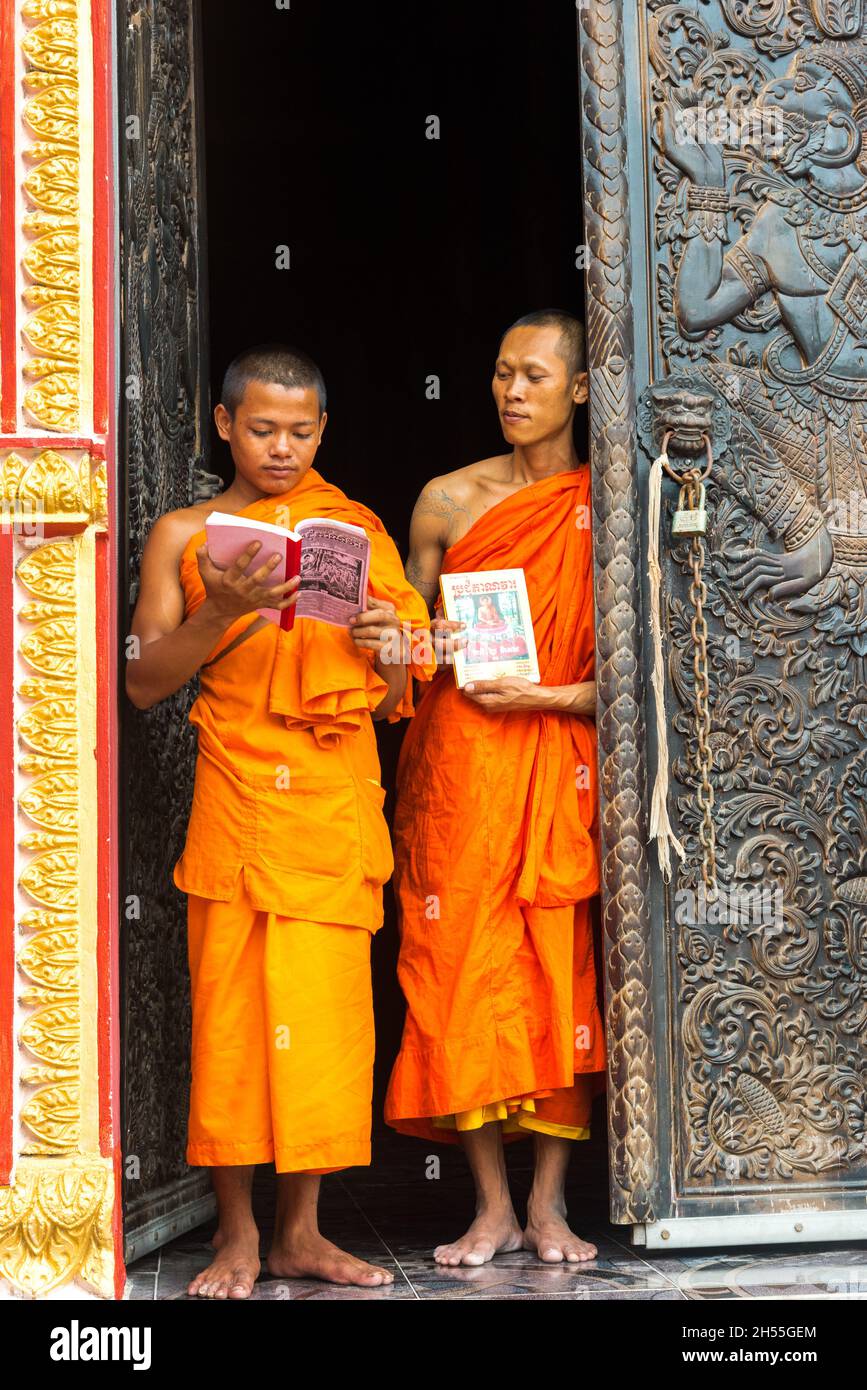 Young monk reading a book on the temple porch Stock Photo - Alamy