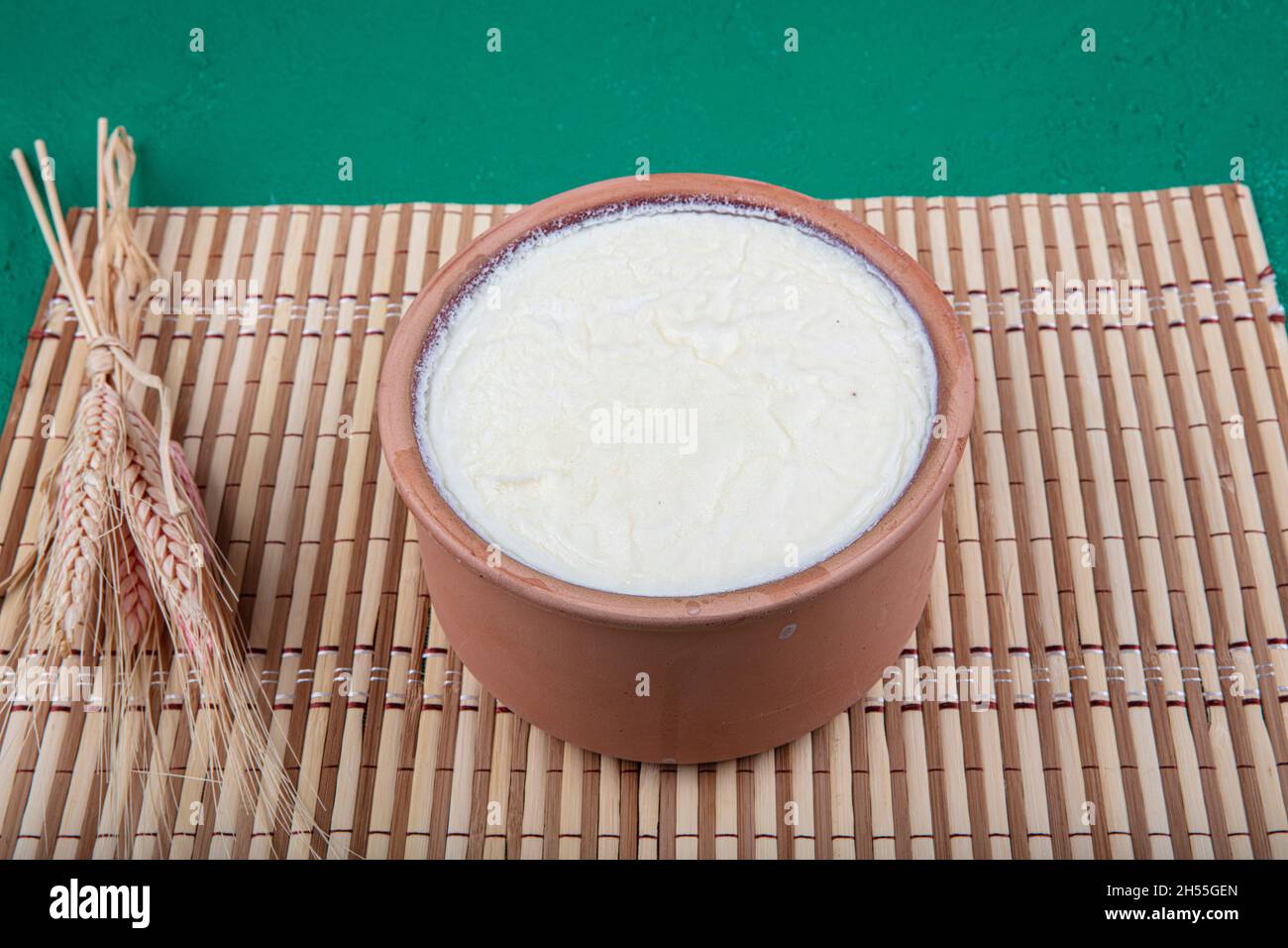 Natural,yogurt in casserole bowl on wooden table with spoon.Close up ...