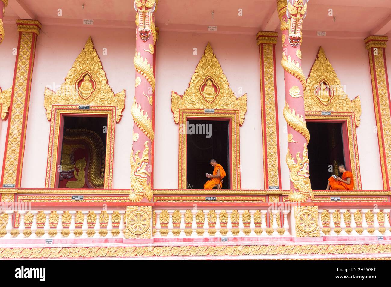 Young monk reading a book on the temple porch Stock Photo - Alamy