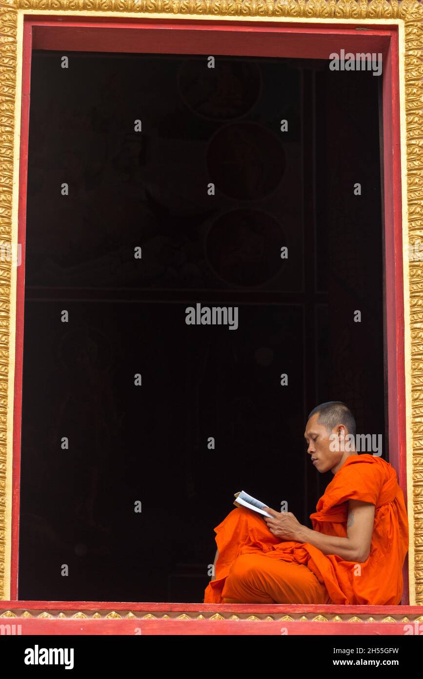 Young monk reading a book on the temple porch Stock Photo - Alamy