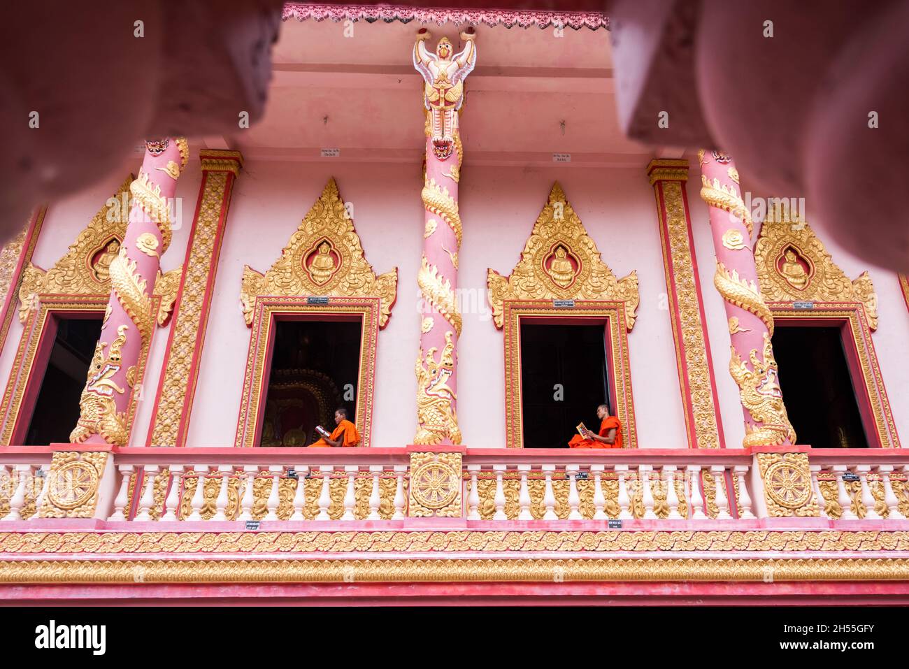 Young monk reading a book on the temple porch Stock Photo - Alamy