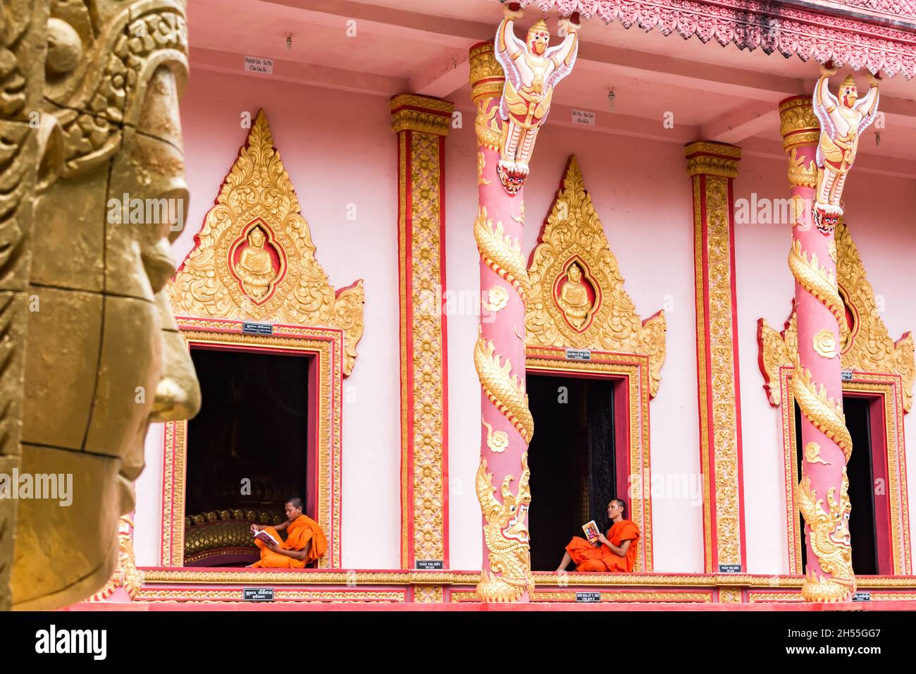 Young monk reading a book on the temple porch Stock Photo - Alamy