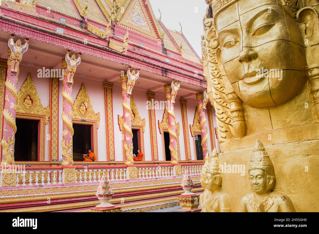 Young monk reading a book on the temple porch Stock Photo - Alamy