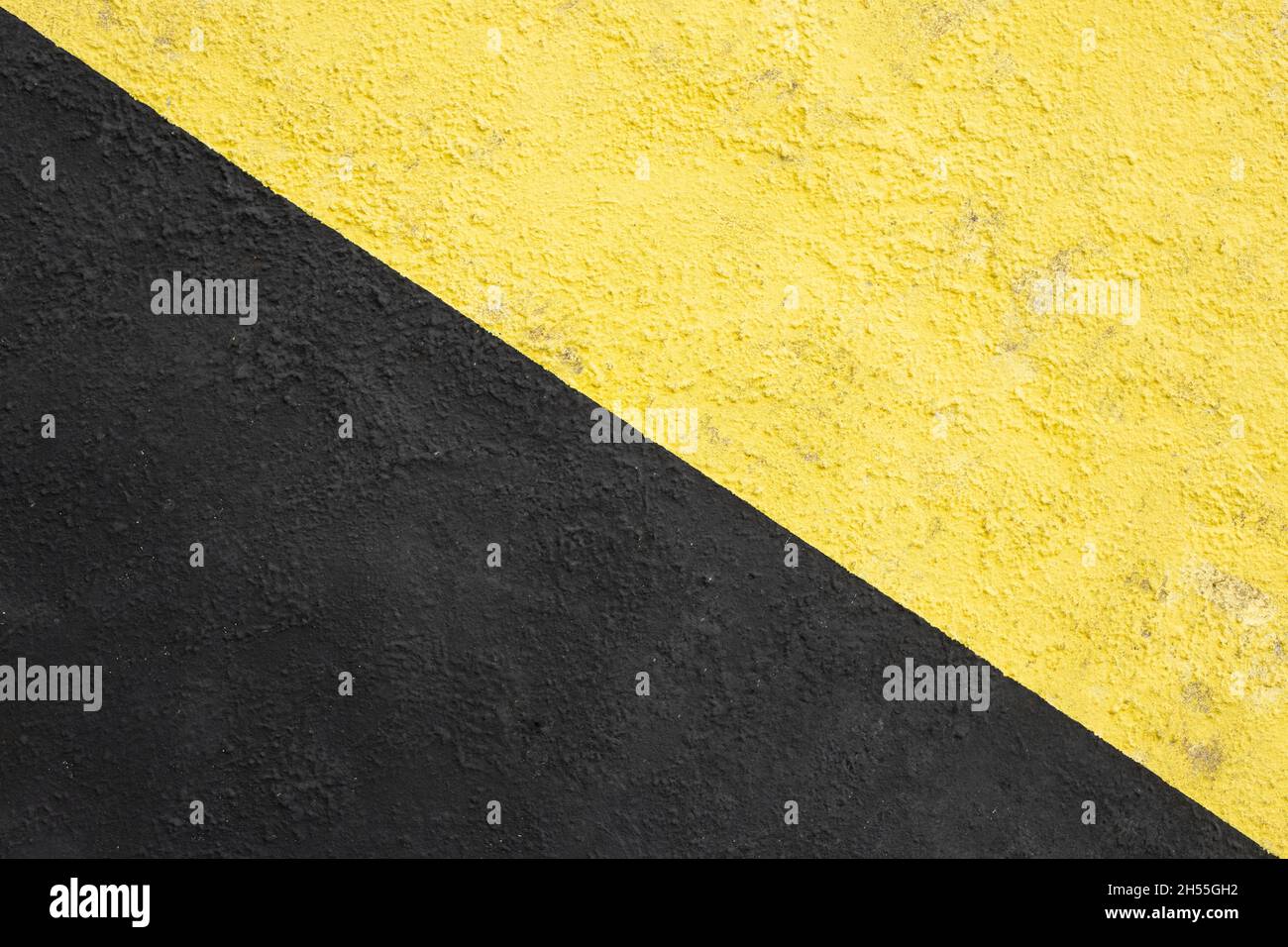 A yellow and black painted wall. divided in two parts by a vertical ...