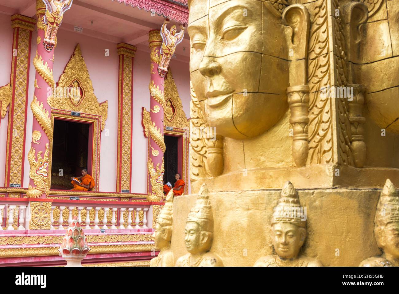 Young monk reading a book on the temple porch Stock Photo - Alamy