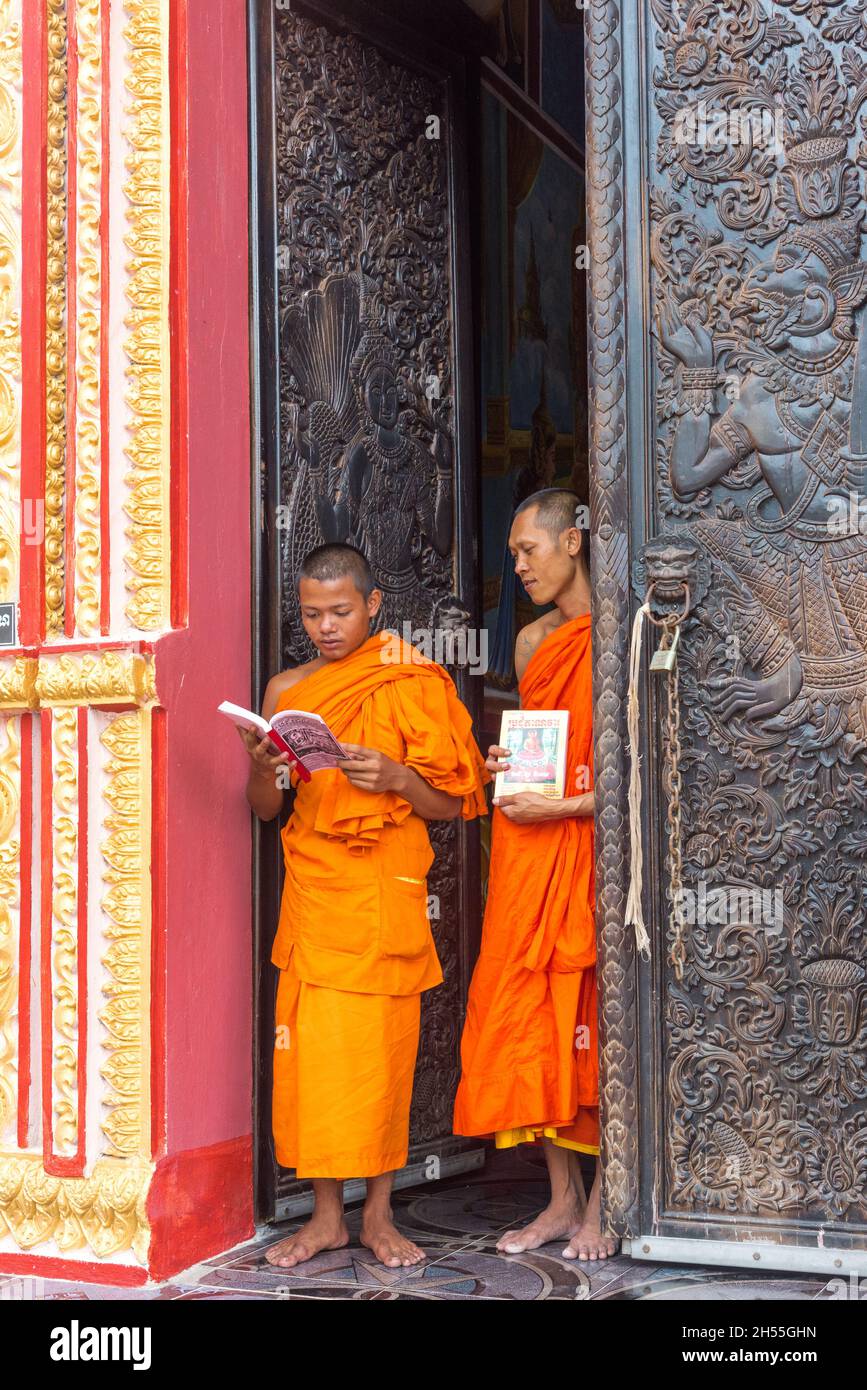 Young monk reading a book on the temple porch Stock Photo - Alamy