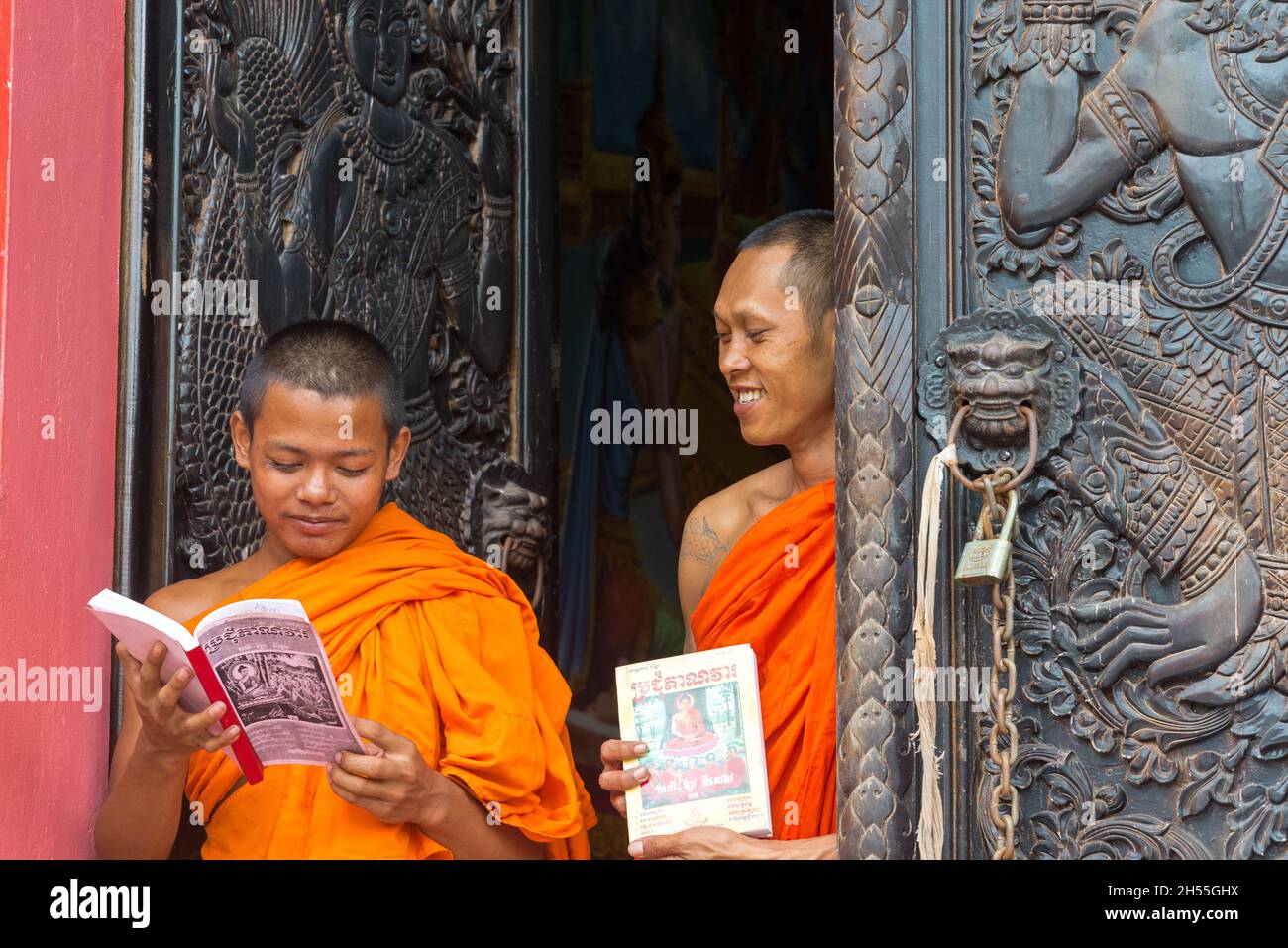 Young monk reading a book on the temple porch Stock Photo - Alamy