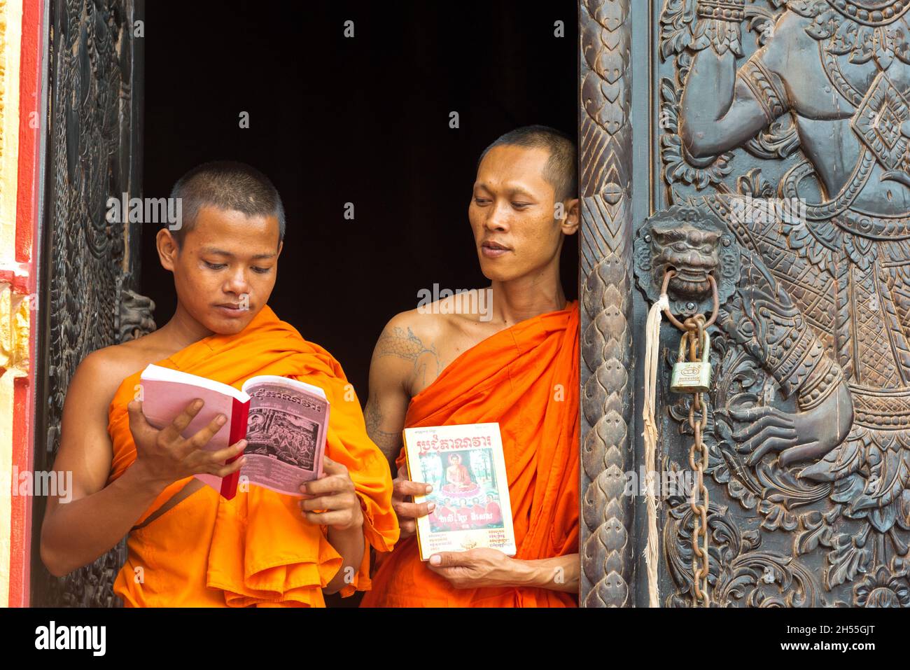 Young monk reading a book on the temple porch Stock Photo - Alamy