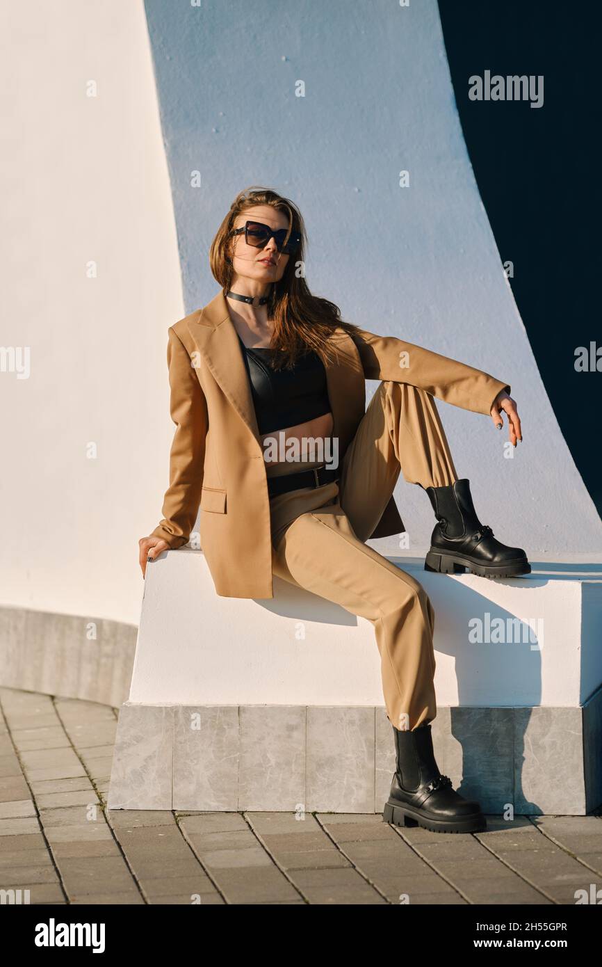 Street fashion, women casual and trendy outfit. Woman in pantsuit ...