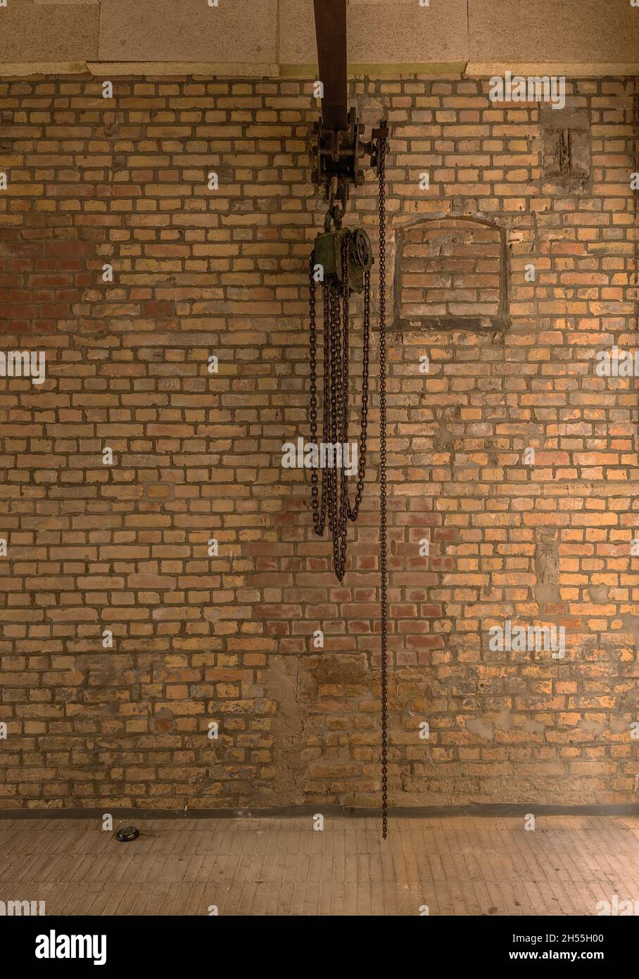 Chain hoist for lifting weights in an old factory Stock Photo - Alamy