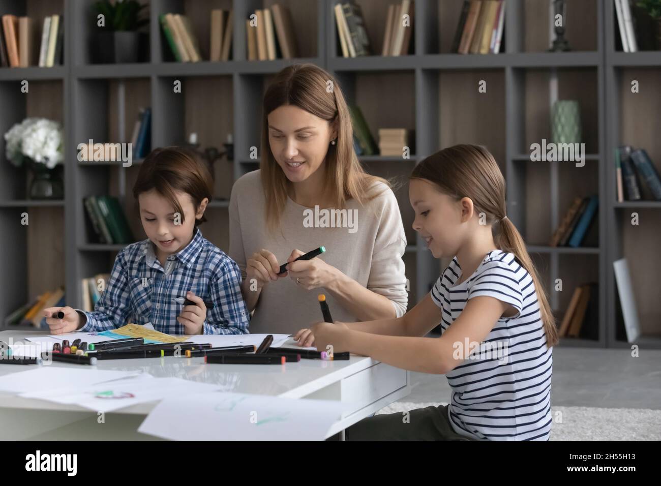 Happy mother with son and daughter drawing having fun together Stock ...