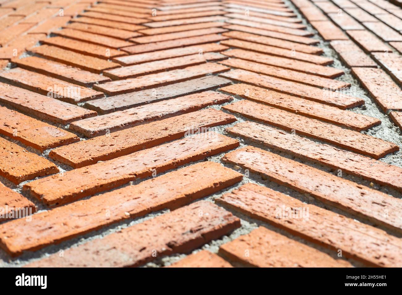 A surface of red bricks placed at different angles. line of flight with ...