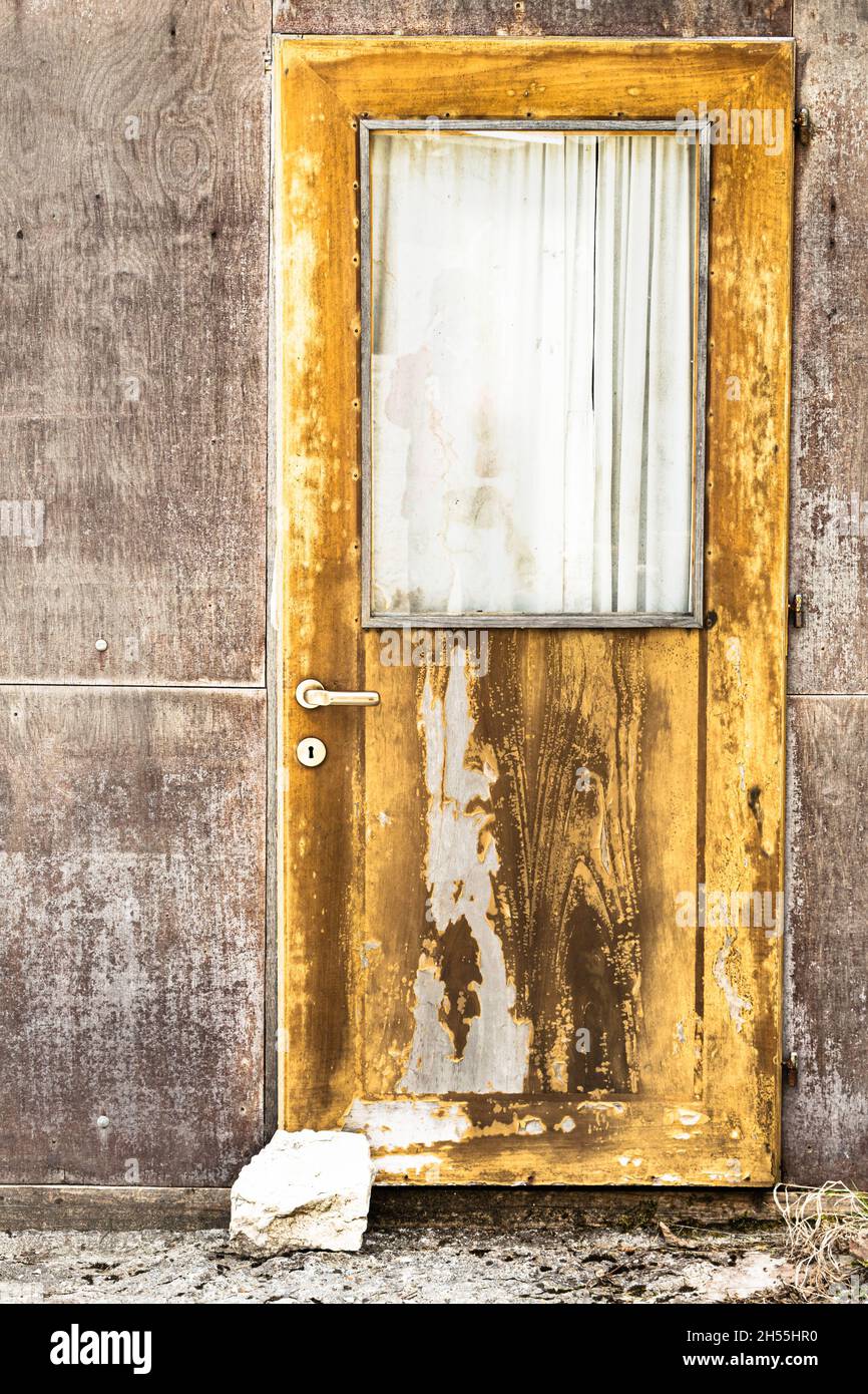 Old and decaying yellow wooden door Stock Photo - Alamy