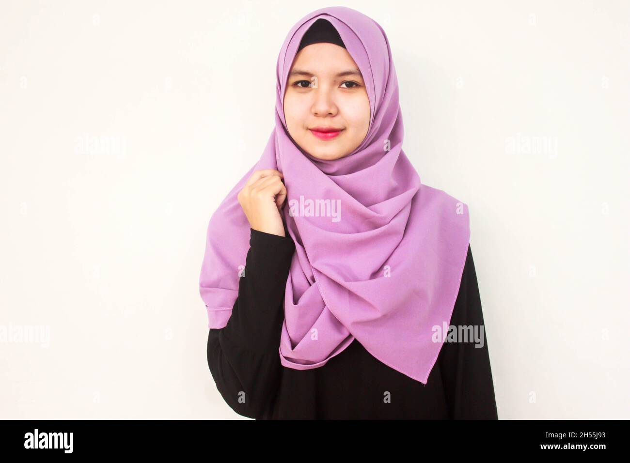An Indonesian woman posing in purple hijab veil Stock Photo - Alamy
