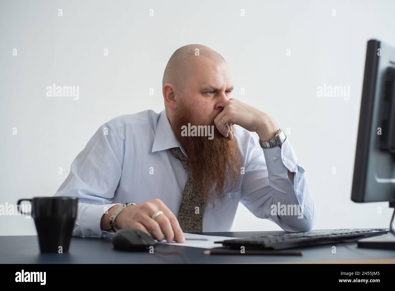 Problems for the office worker. A bald man in a white shirt sits at a ...