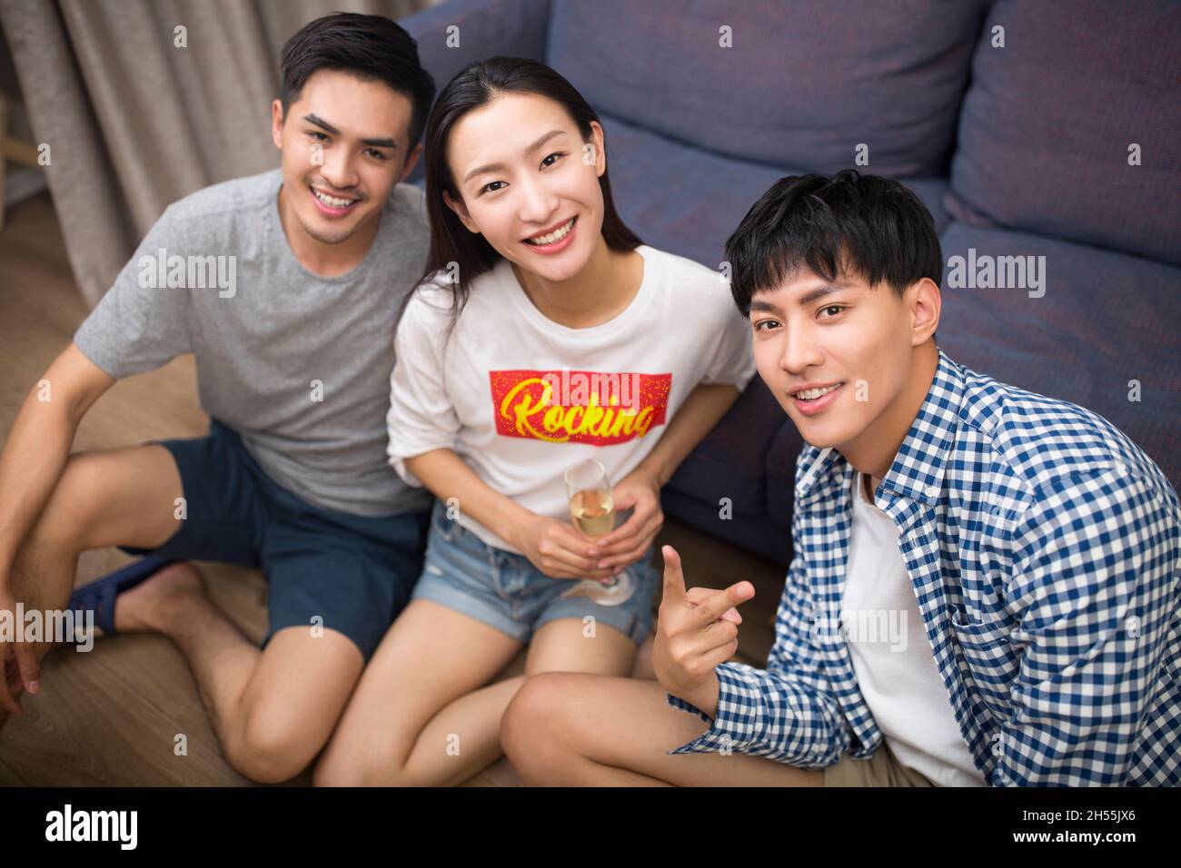 Happy young people gathering at home Stock Photo - Alamy