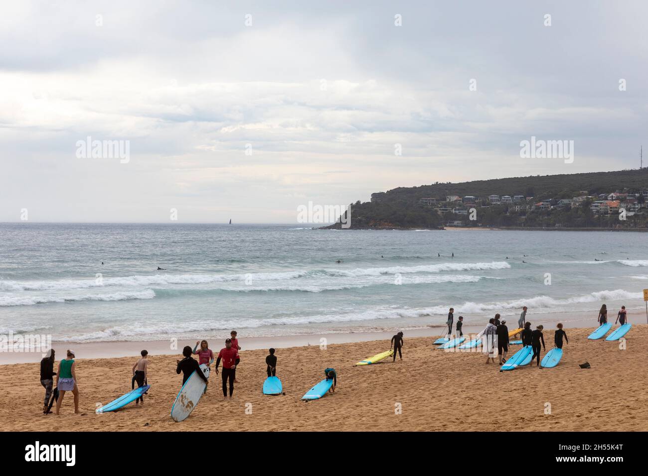 Learn to surf class, group of young children on Manly Beach ready for a ...