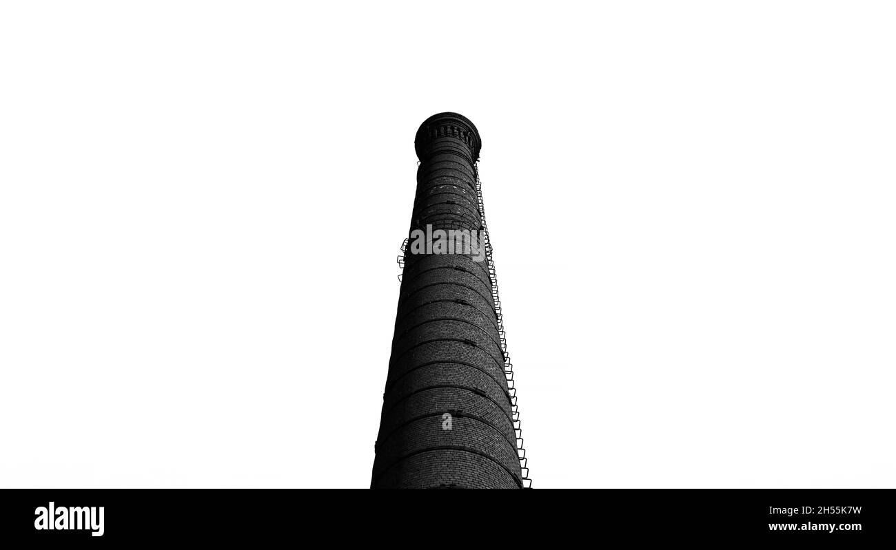 A large chimney in an old factory. smoke stack An old black brick ...