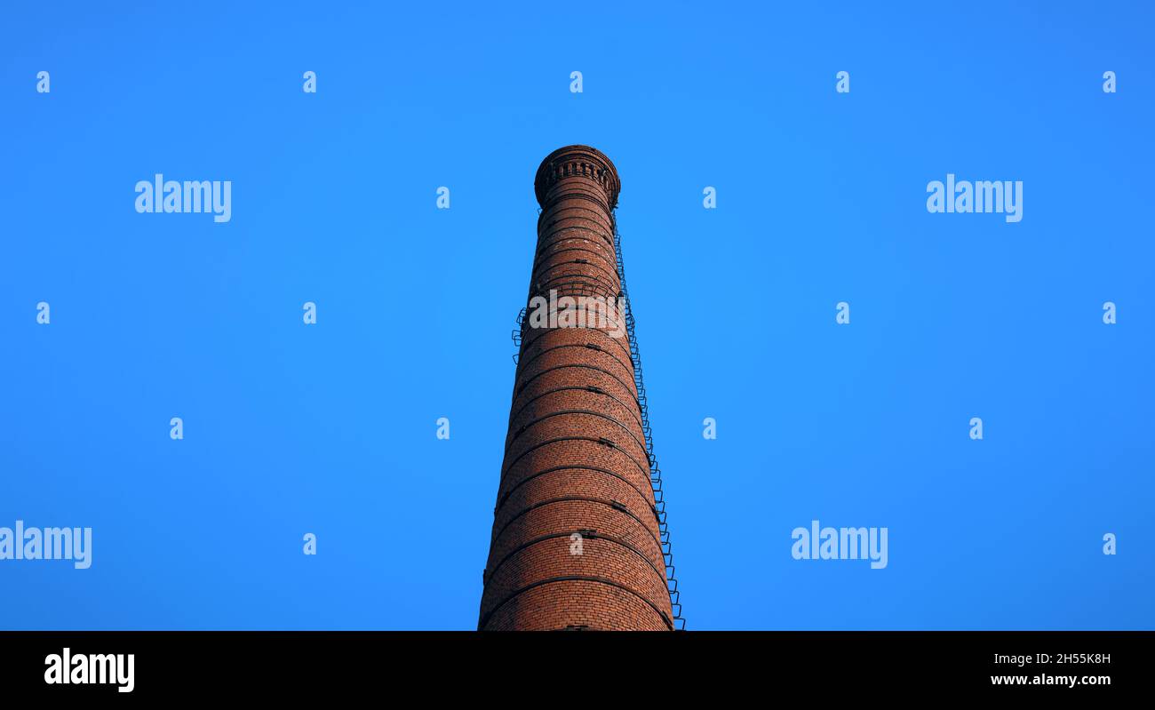 tall chimney old red bricks in an old factory. smoke stack An old brick ...