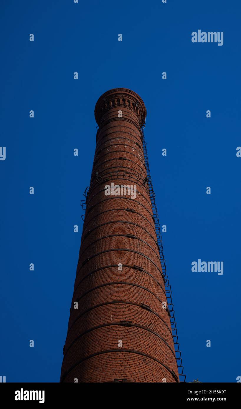 tall chimney old red bricks in an old factory. smoke stack An old brick ...