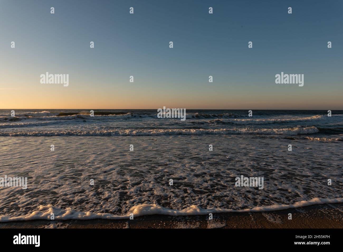 Sunset on the beach with brilliant lighting Stock Photo - Alamy