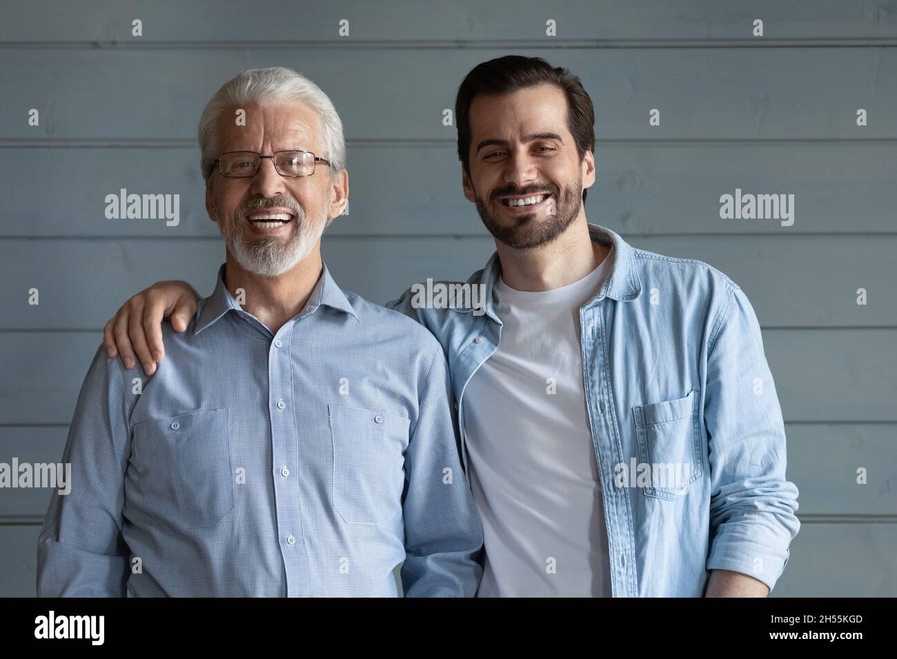 Smiling mature dad young adult child hug look at camera Stock Photo - Alamy