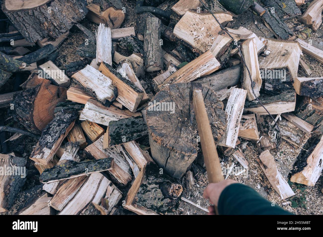 The ax lies on the wood. Firewood chopping. Preparation of firewood for ...