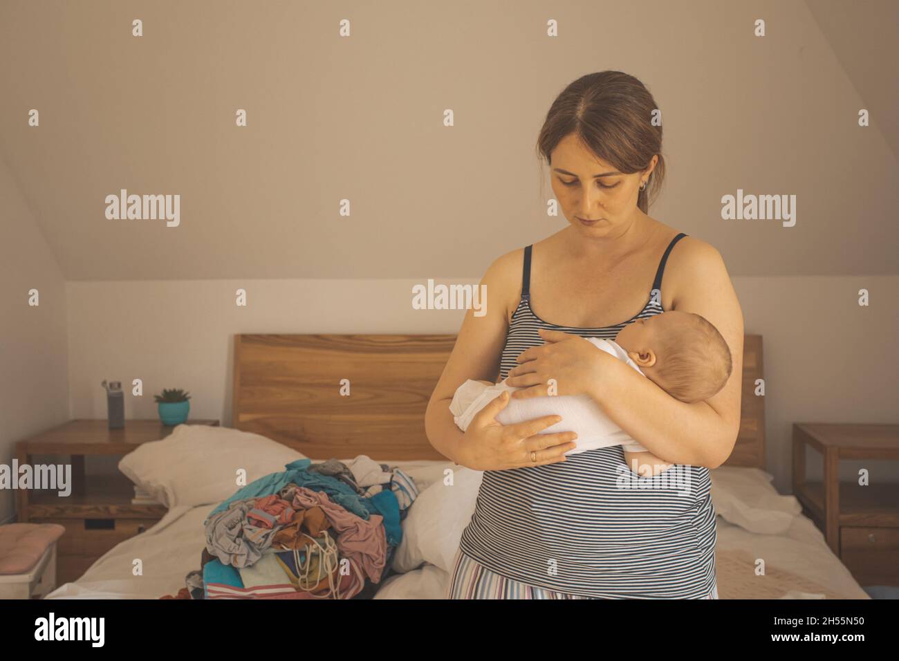 Beautiful young mother holding her son in her arms Stock Photo - Alamy