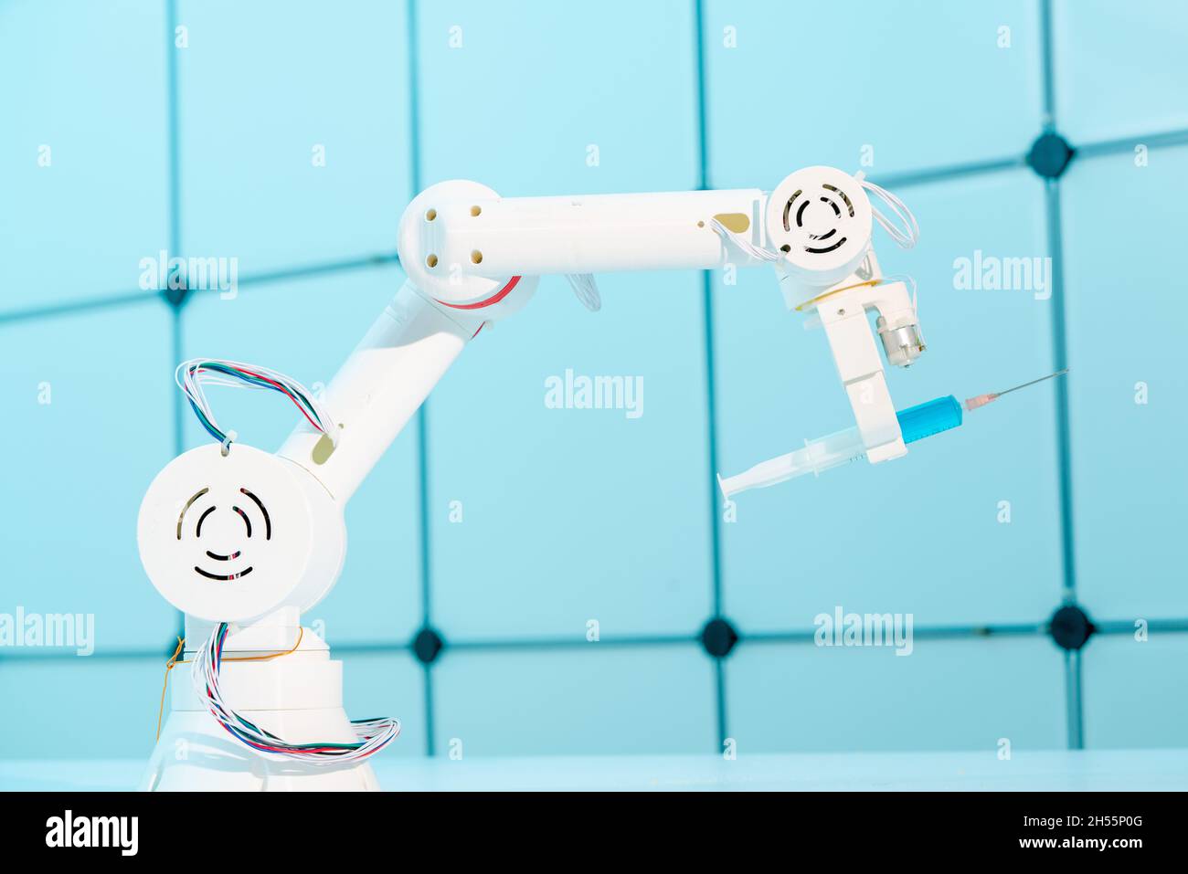Robot hand with a medical syringe. Future medicine concept using robots ...