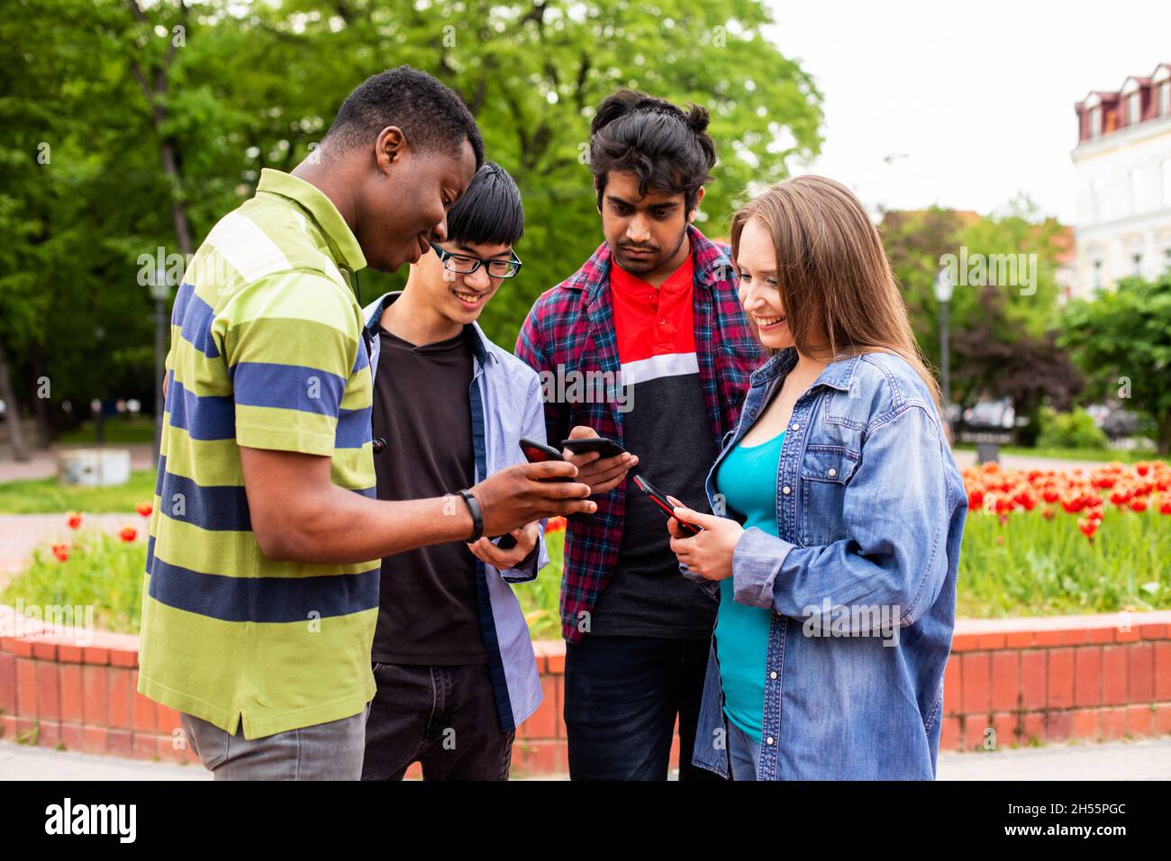Multiethnic university students checking information using mobile ...