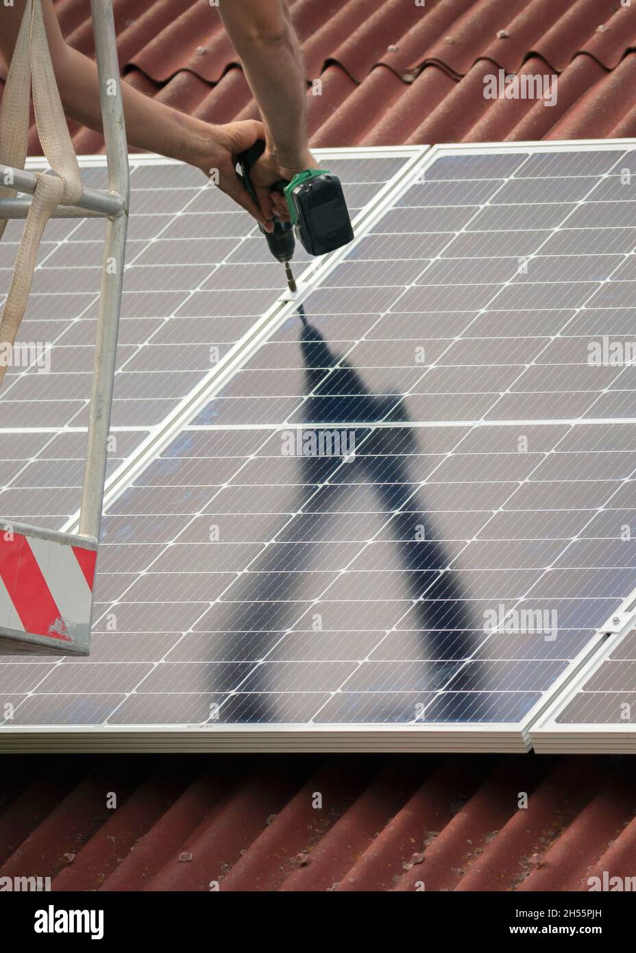 Montage of solar panel on a roof top Stock Photo - Alamy