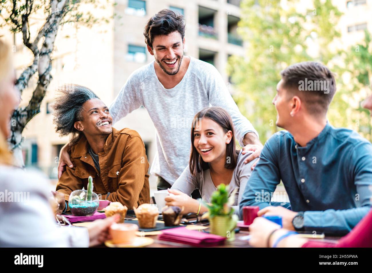 Multicultural friends drinking cappuccino at coffee bar restaurant ...
