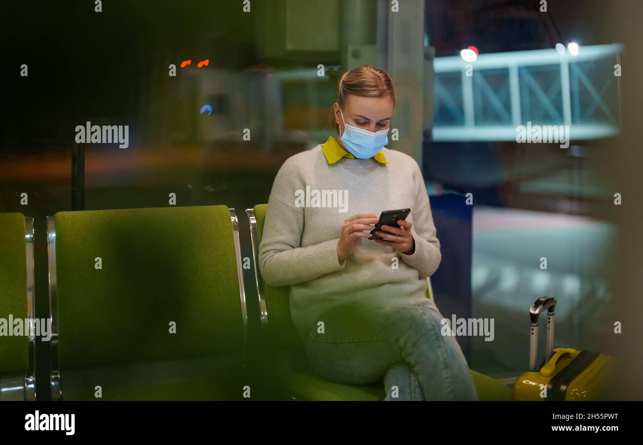 Woman in medical mask waiting for her check-in at the airport Stock ...