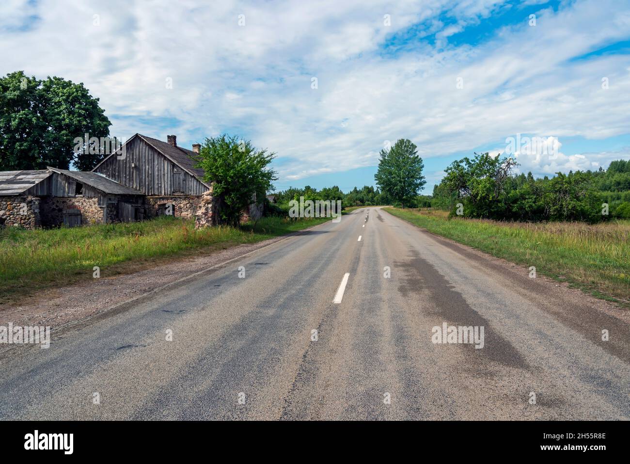 Natural road in countryside with old house Stock Photo - Alamy