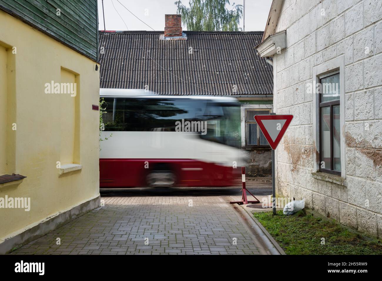Big bus on narrow street of a small city Stock Photo - Alamy