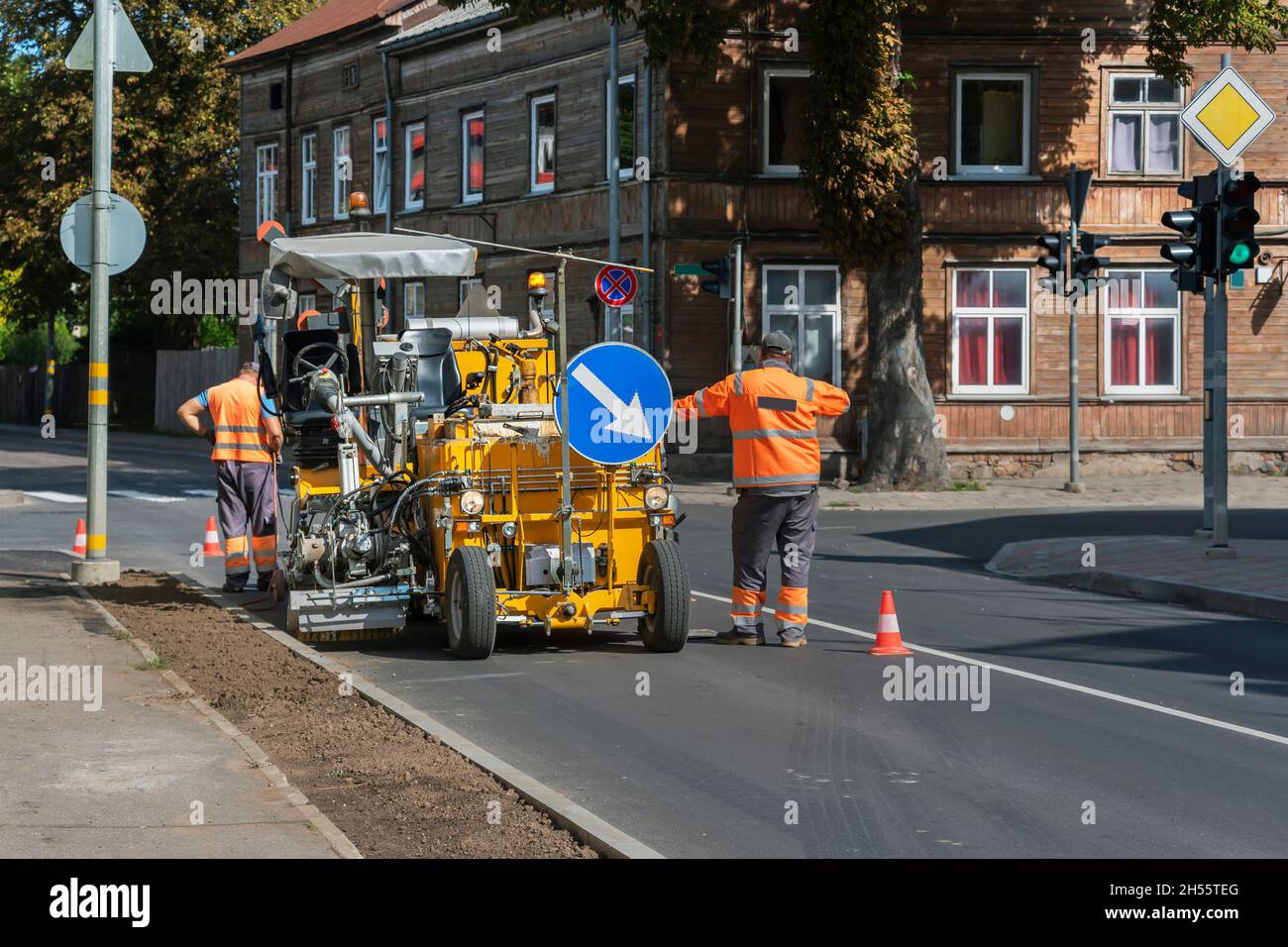 Men works on the road in small city Stock Photo - Alamy
