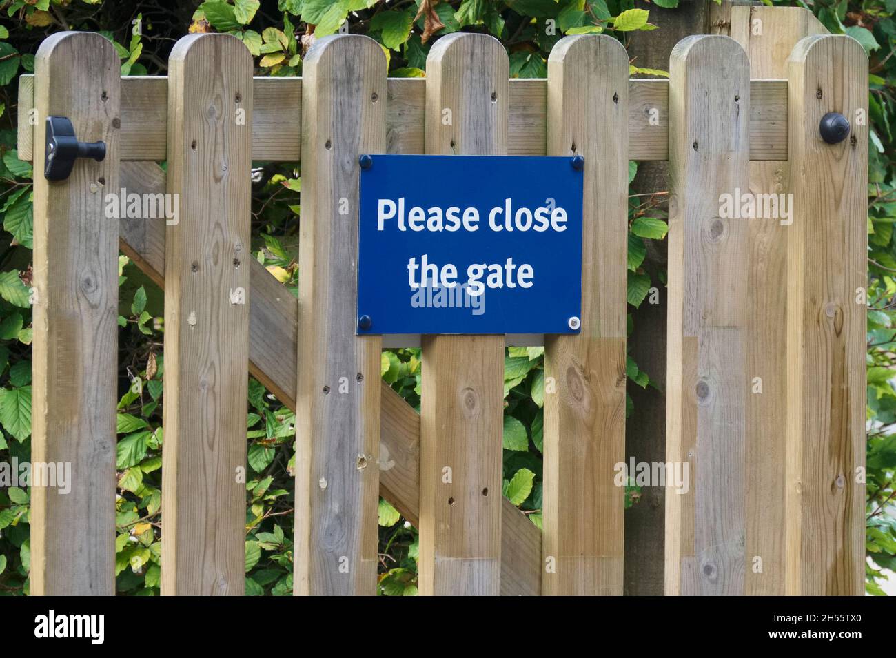Please close gate sign on wooden fence at. children's play park Stock ...