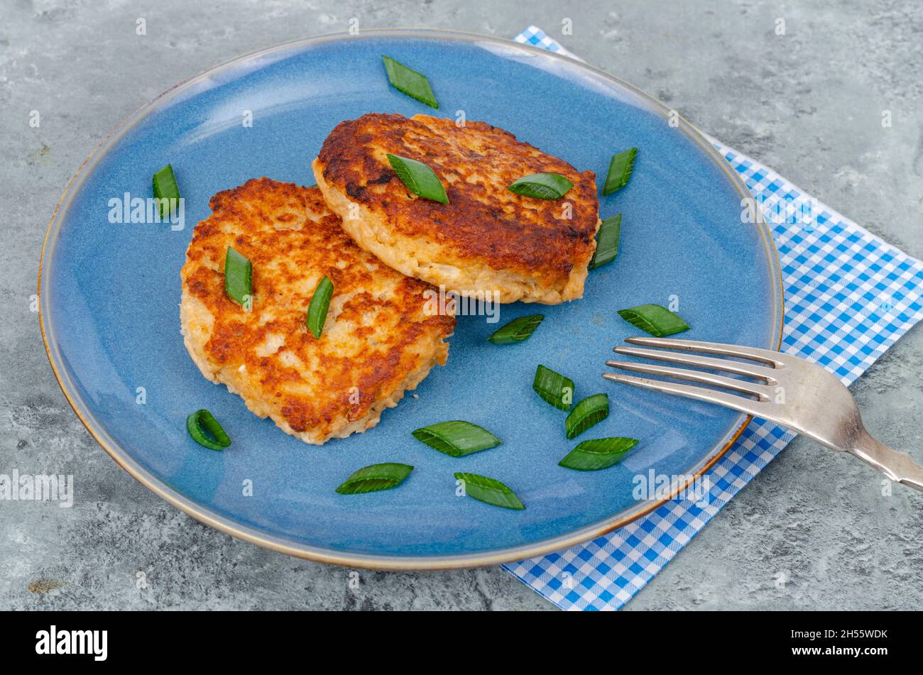 Blue plate with two minced meat cutlets. Studio Photo Stock Photo - Alamy