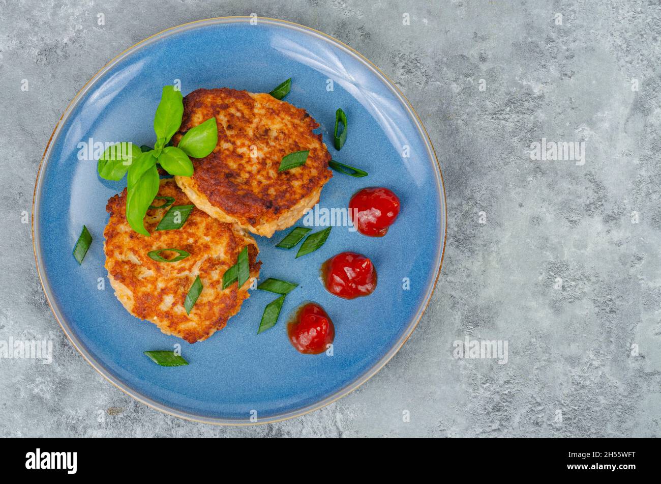 Blue plate with two minced meat cutlets. Studio Photo Stock Photo - Alamy