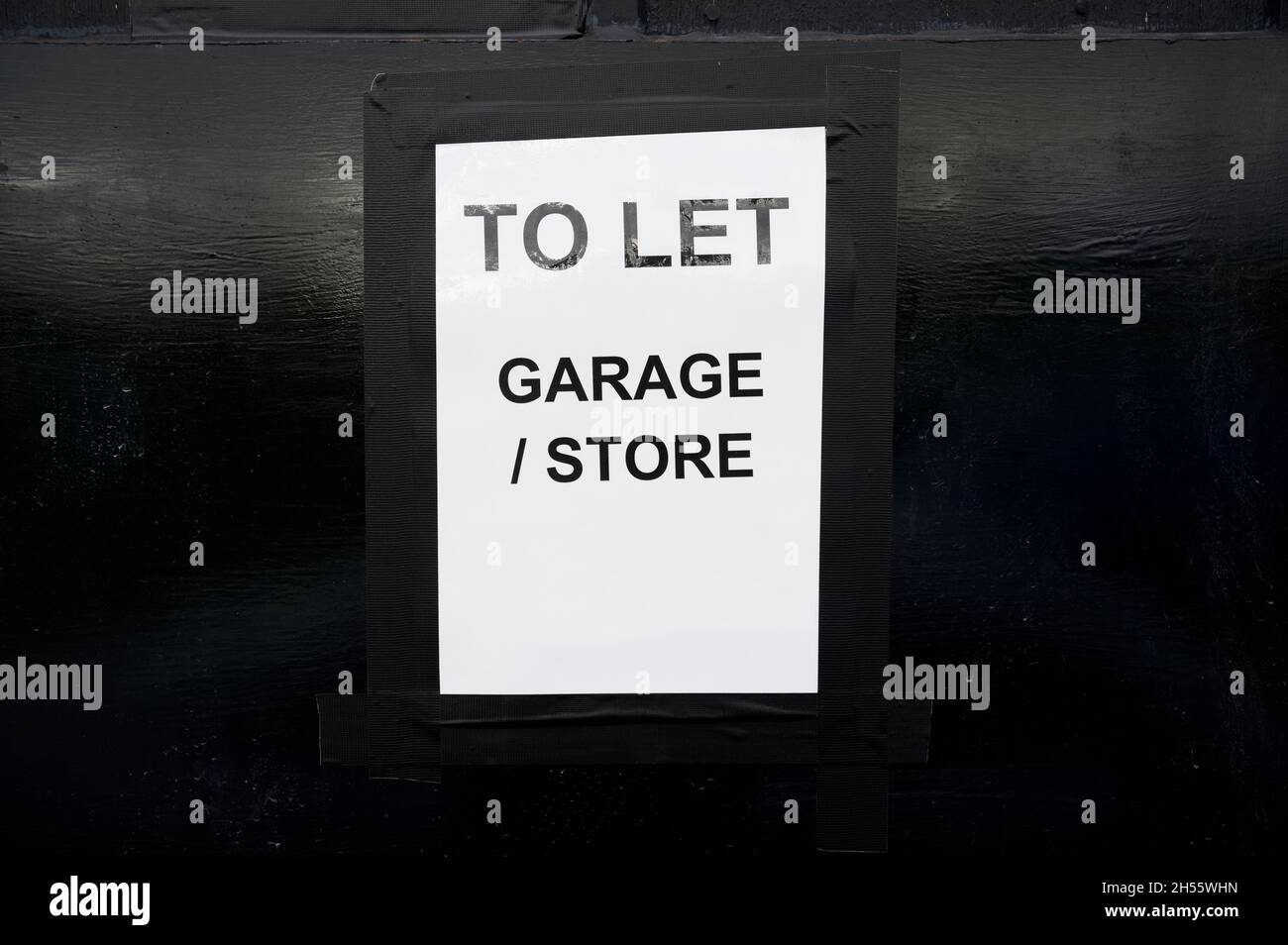 Garage and store to let sign due to closed business Stock Photo - Alamy
