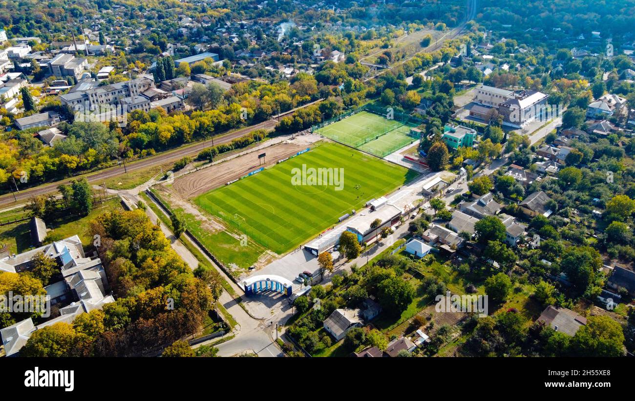 Aerial view of an empty soccer football field in town with railway ...