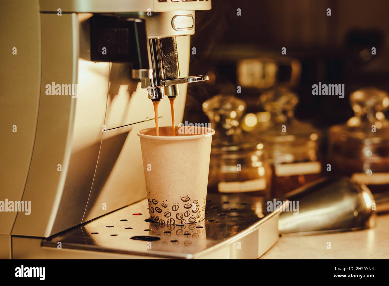 Instant coffee making process. Hot water pouring from metal electric ...