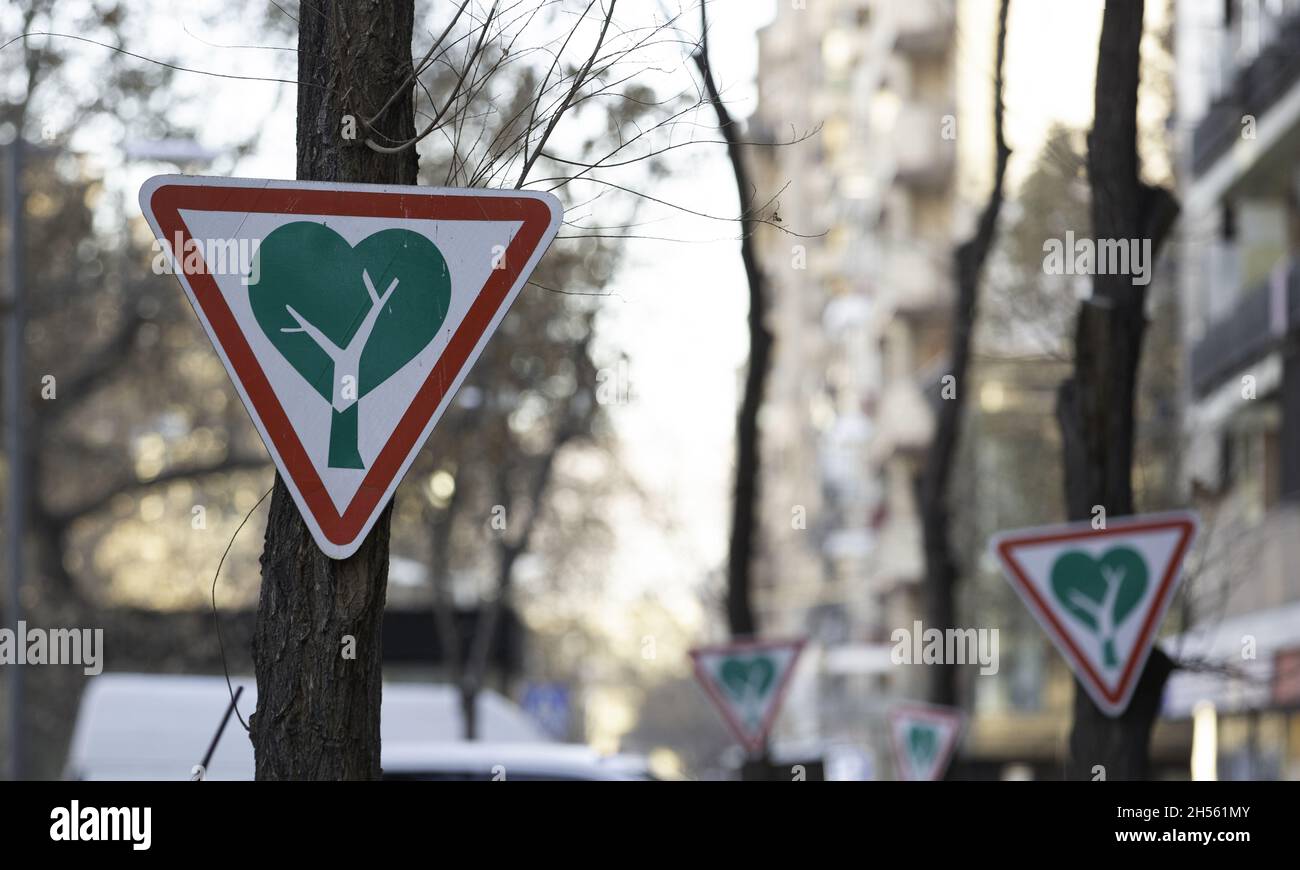 The warning nature signs on tree trunks Stock Photo - Alamy