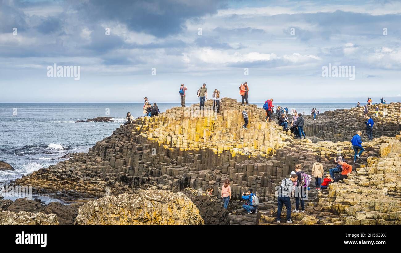 Bushmills, Northern Ireland, Aug 2019 Tourists sightseeing hexagonal ...