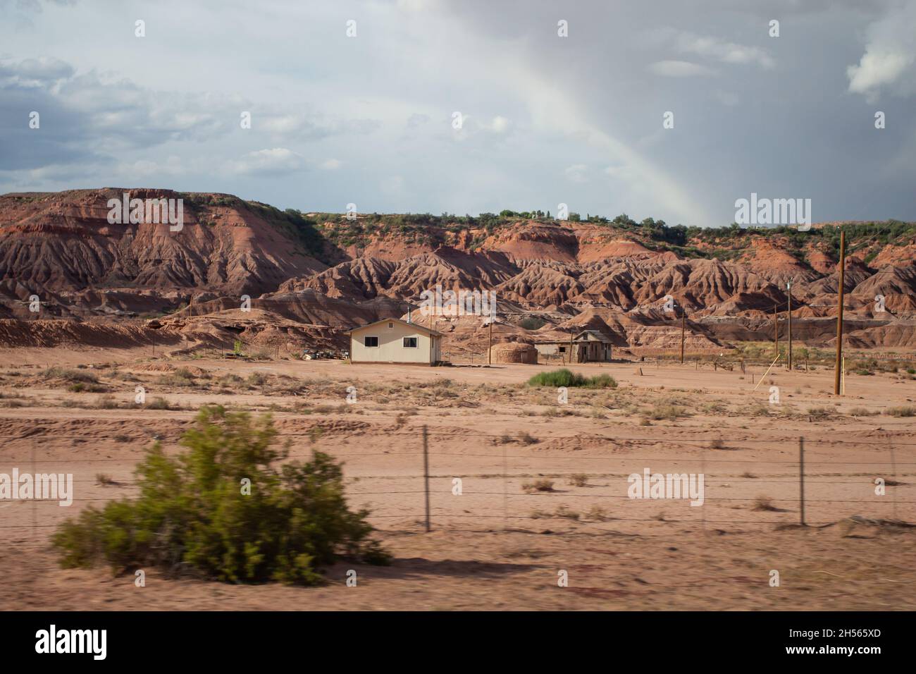 Houses in barren land landscape, photo taken from driving car ...