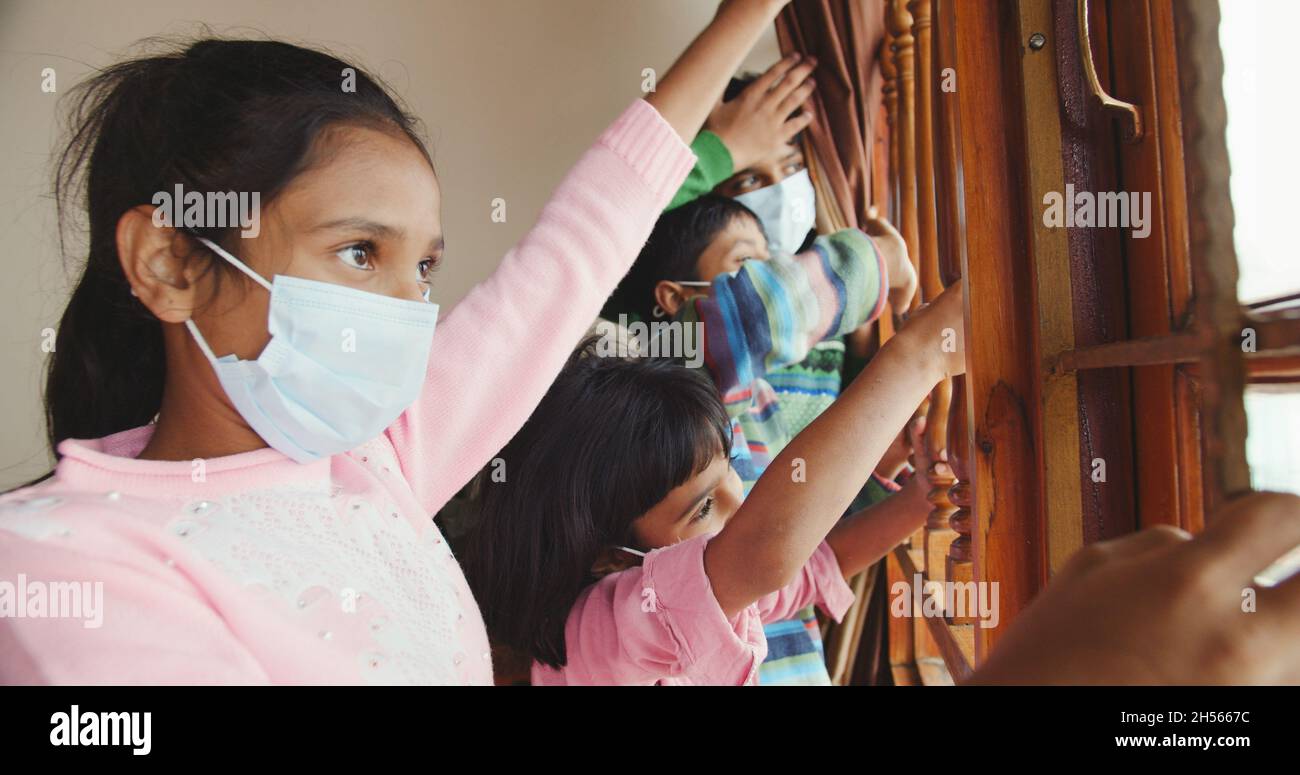 Cute children with masks playing at home Stock Photo - Alamy